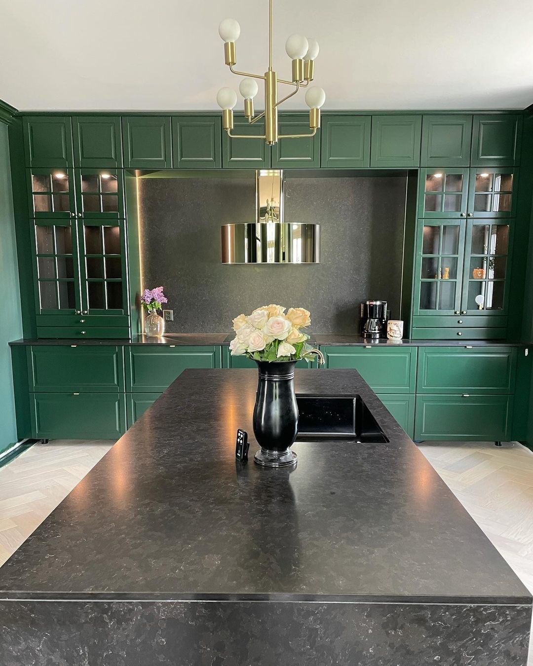 Charming kitchen in dark green and Silestone Corktown as worktops