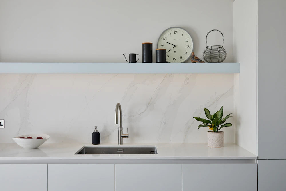 Charming kitchen in dark green and Silestone Corktown as worktops